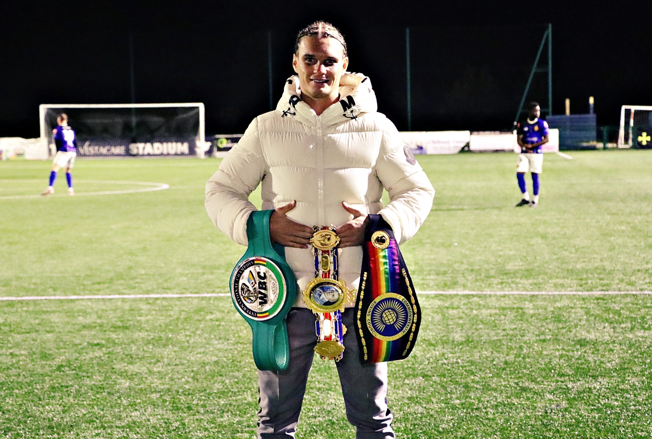 Champion boxer brings belts to his former football club - Mancunian Matters